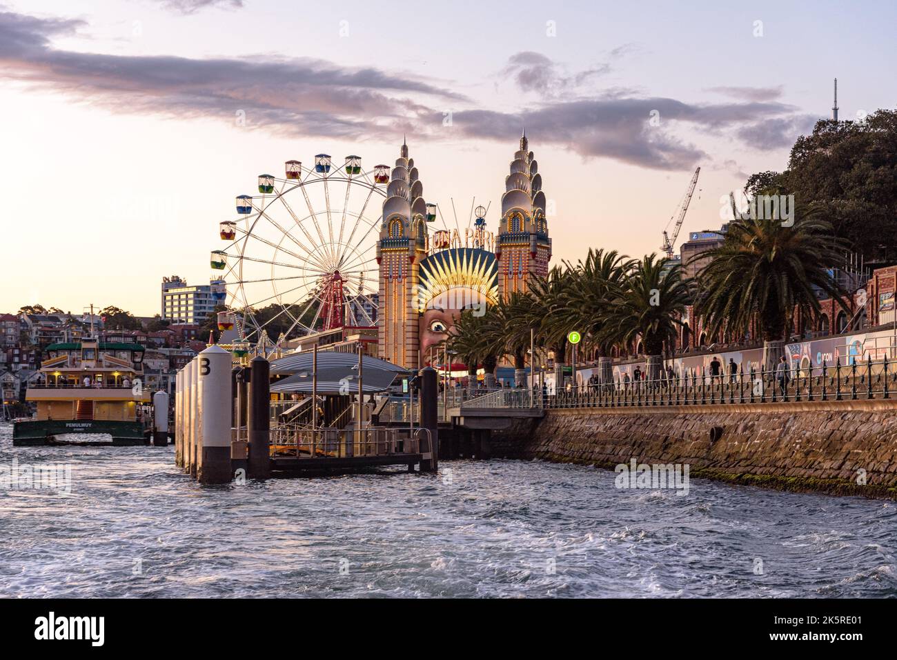 Milsons Point Wharf in front of Luna Park in Sydney at dusk Stock Photo ...
