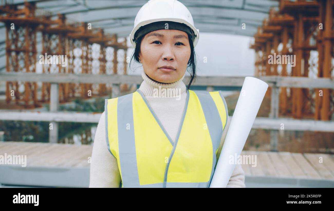 Portrait of successful construction worker Asian woman in helmet and ...