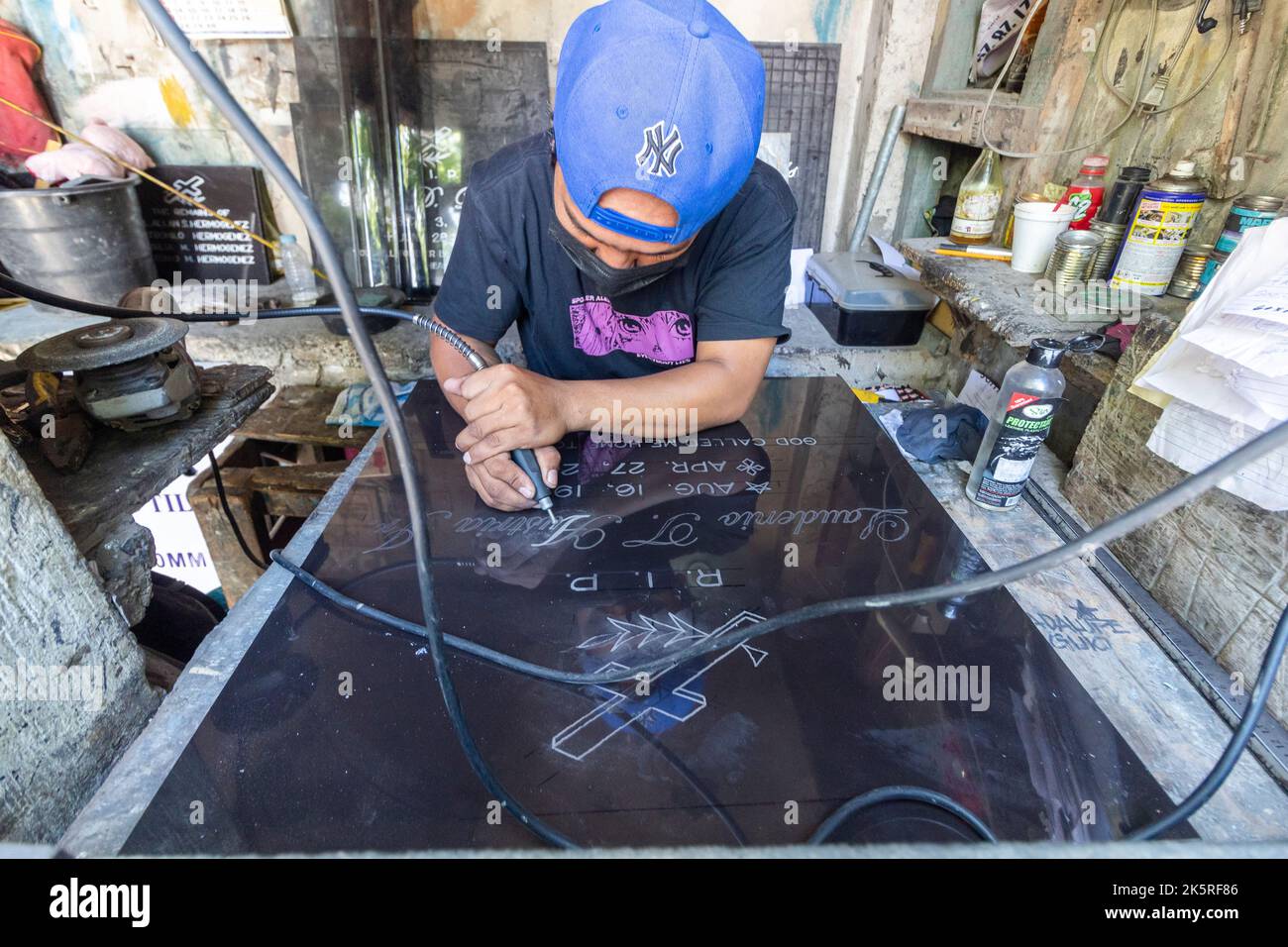 A lapida maker working on a marble tombstone in Cebu City, Philippines ...
