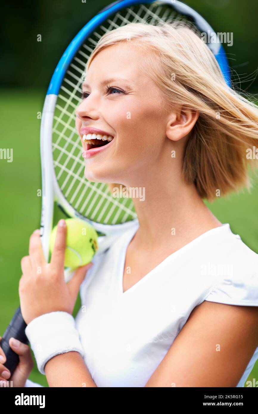 The joy of the game. A young tennis player with the wind in her hair ...