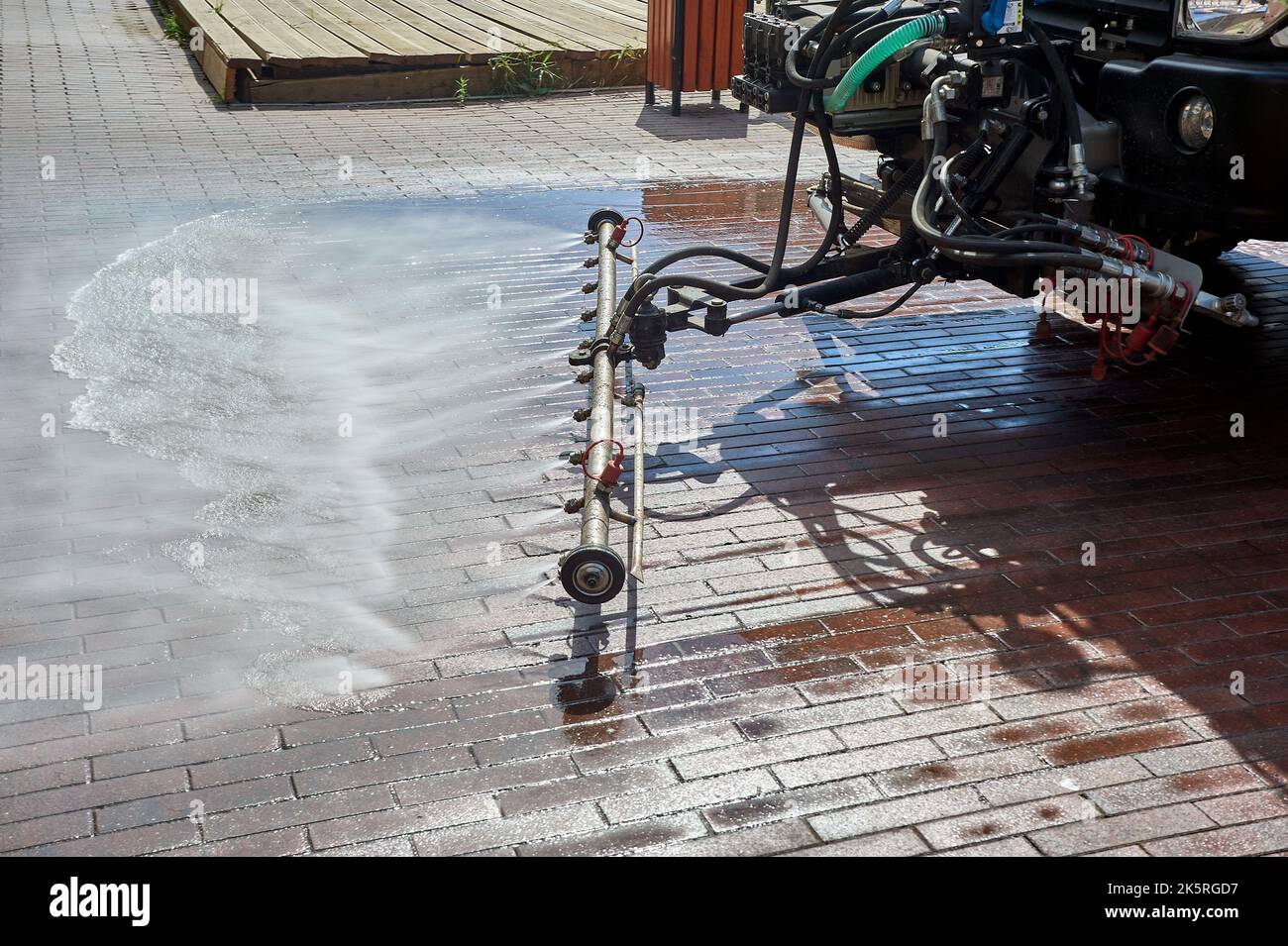 A special machine washes city paths and roads with water Stock Photo ...