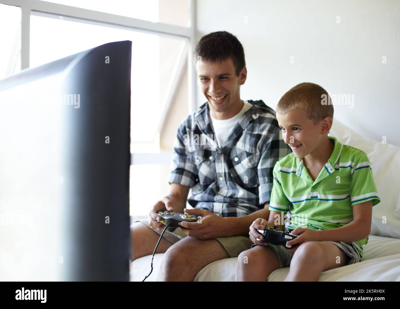 This is how its done. Older brother playing video games with his ...