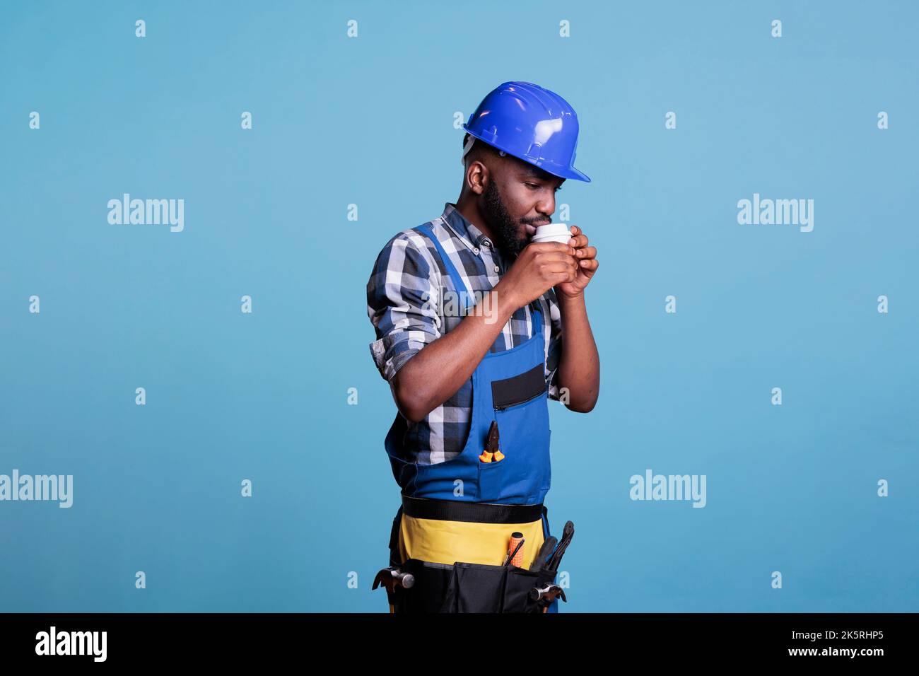 Construction worker enjoying a hot coffee early in the morning upon ...