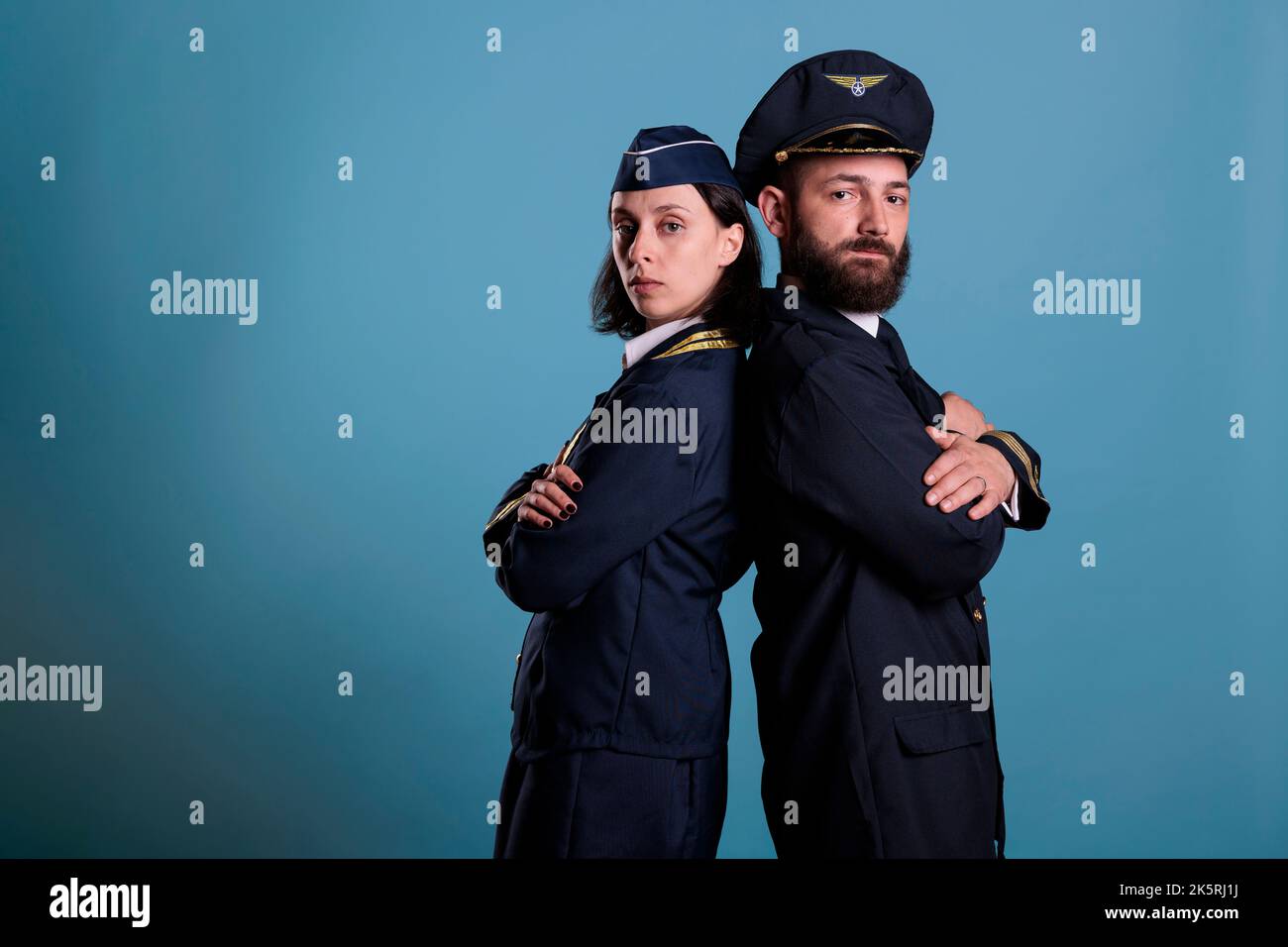 Airplane captain and flight attendant in professional airline uniform ...