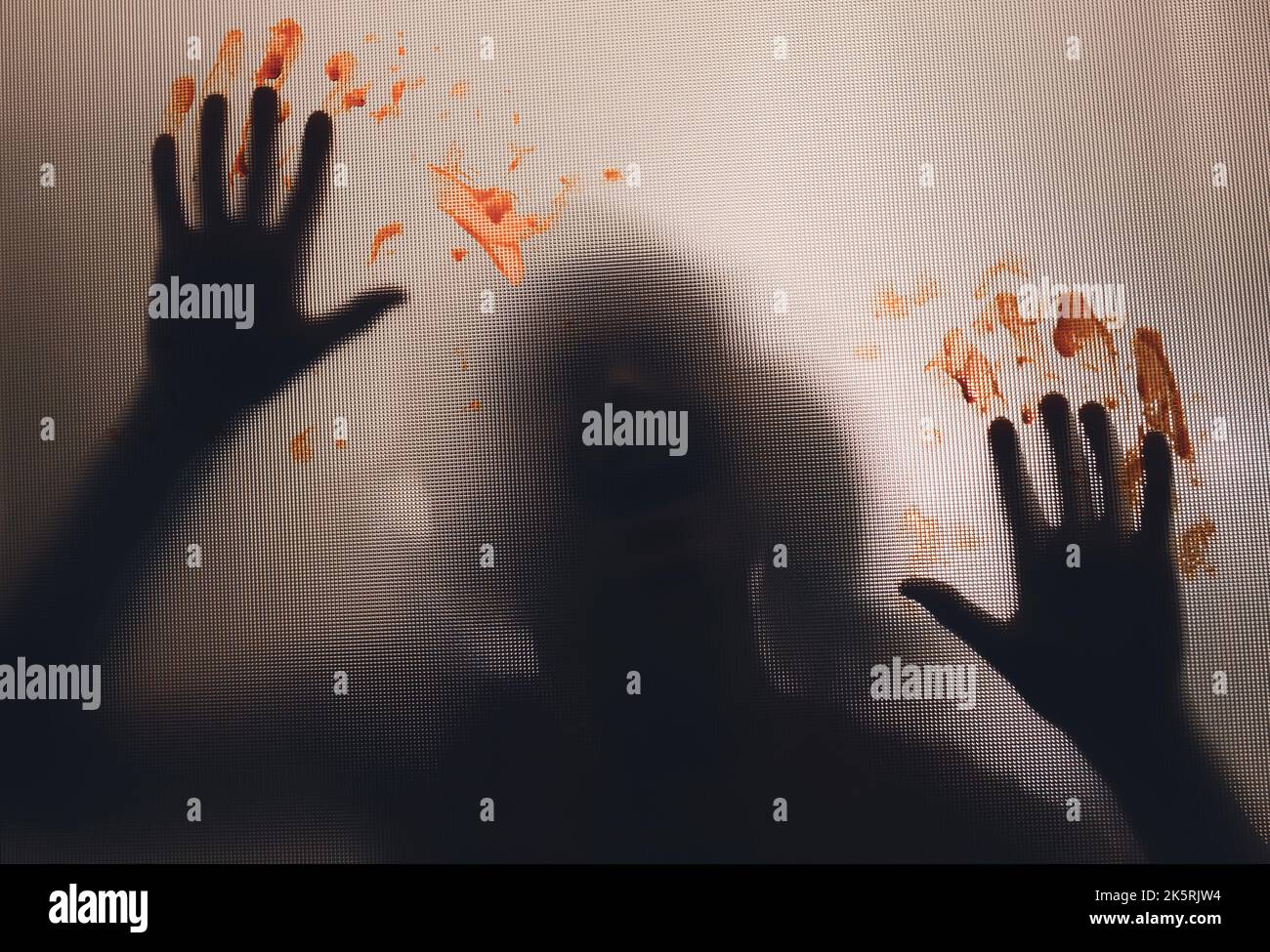 Horror ghost girl behind the matte glass with blooded hands. Halloween ...