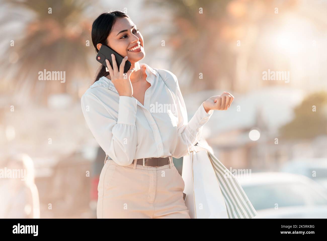 Woman, phone and smile for call while shopping on street in city for ...