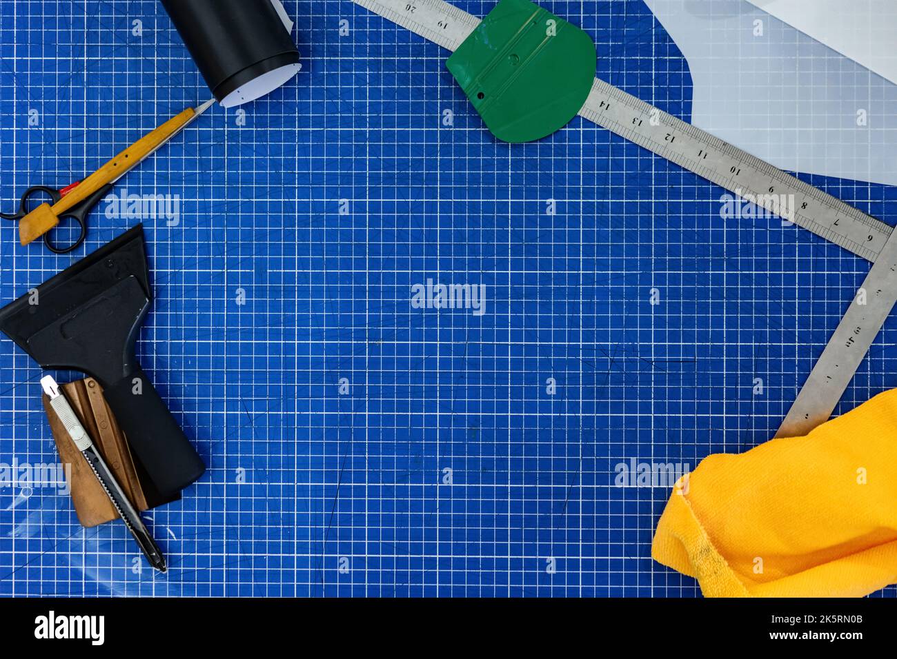 Desktop top view with blue cutting mat Stock Photo - Alamy