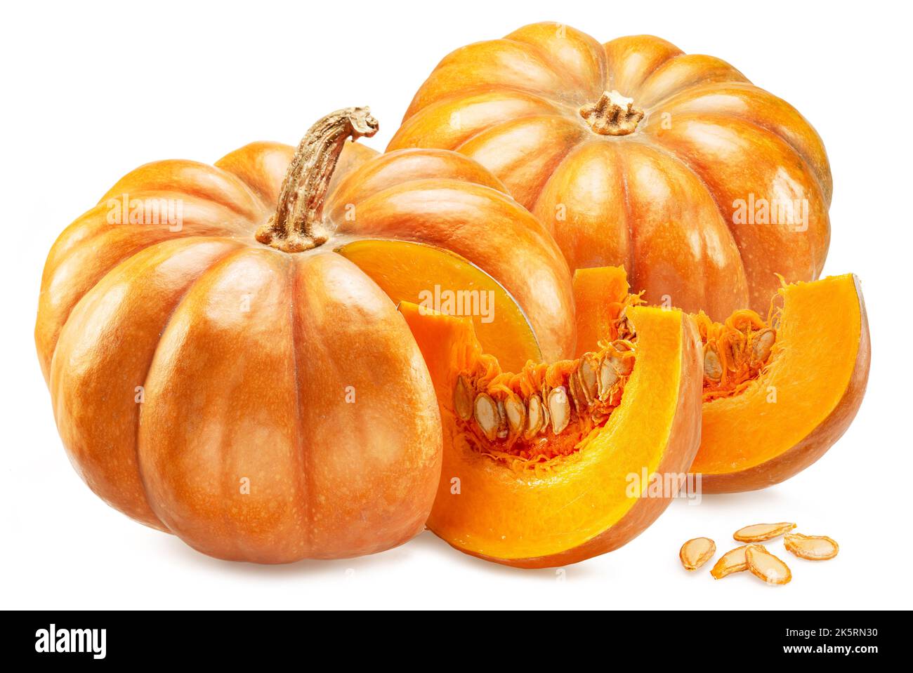 Orange round pumpkins, pumpkin slices andpumpkin seeds isolated on ...