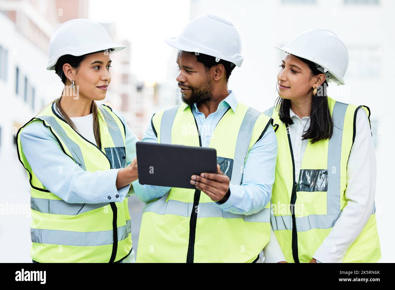 Teamwork, construction workers and digital tablet by team collaboration ...