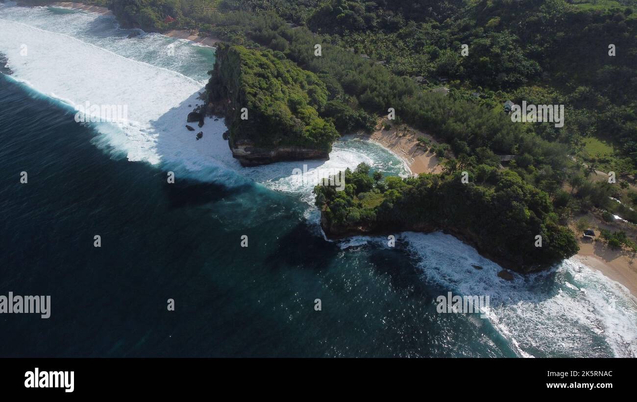 A bird's eye view of Batu Bengkung Beach covered with greenery on Java ...