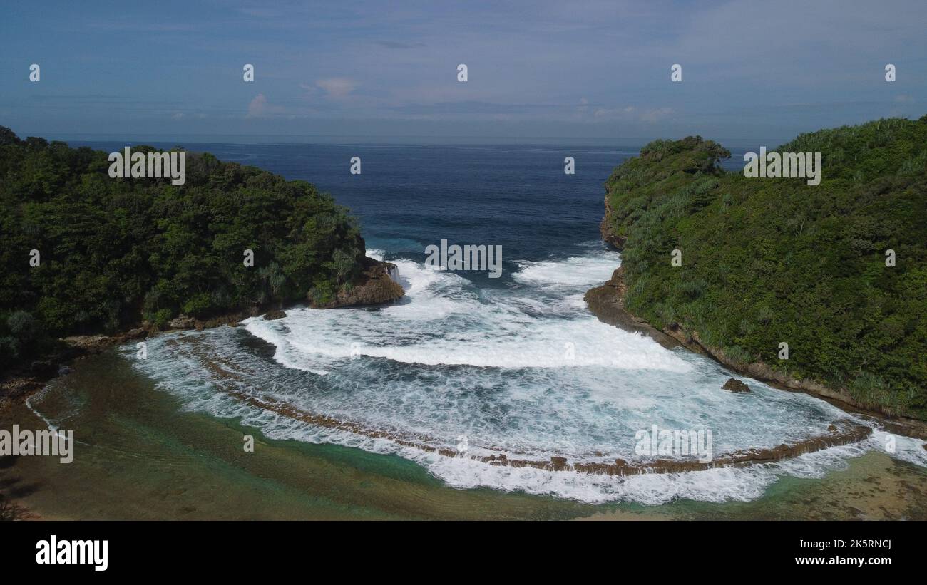 A bird's eye view of Batu Bengkung Beach covered with greenery on Java ...
