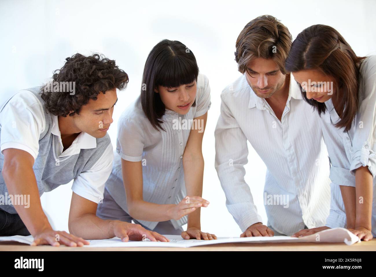 Brainstorming design. A group of architects looking over some ...