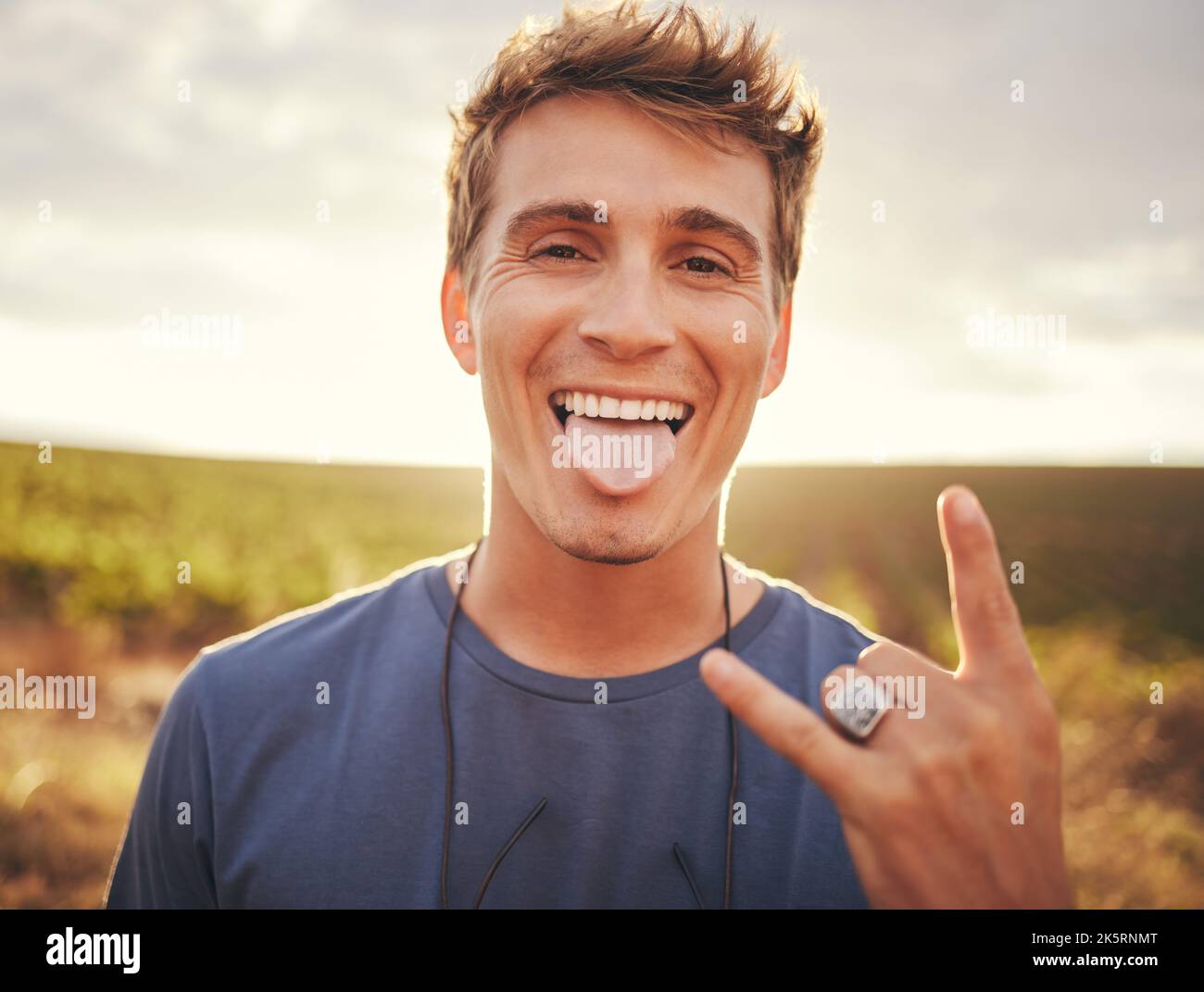 Man, hands and portrait of rock sign for travel tour or vacation in the ...