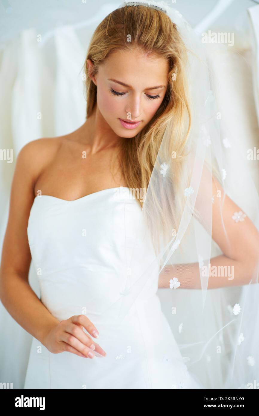 Its all coming together. A young bride trying on a wedding dress Stock ...