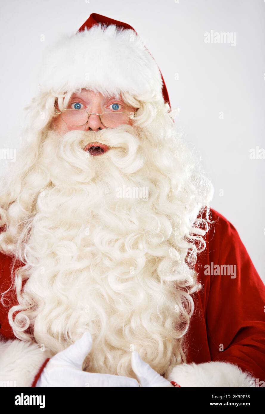 Surprised Santa. Close-up of Santa holding his belly and looking ...