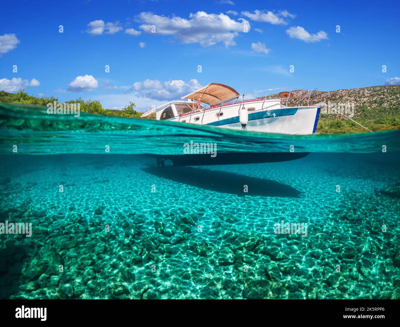 Split view - half underwater view of beautiful seabed with sea fishes ...