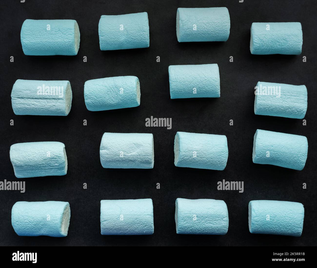 Blue marshmallows on dark background Stock Photo - Alamy