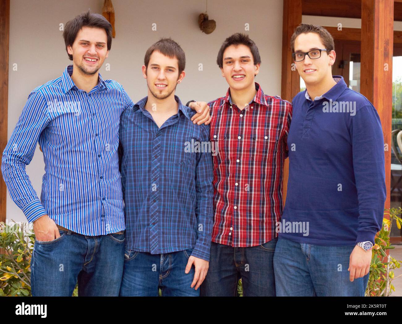 Brothers standing together. Portrait of a group of young men standing ...