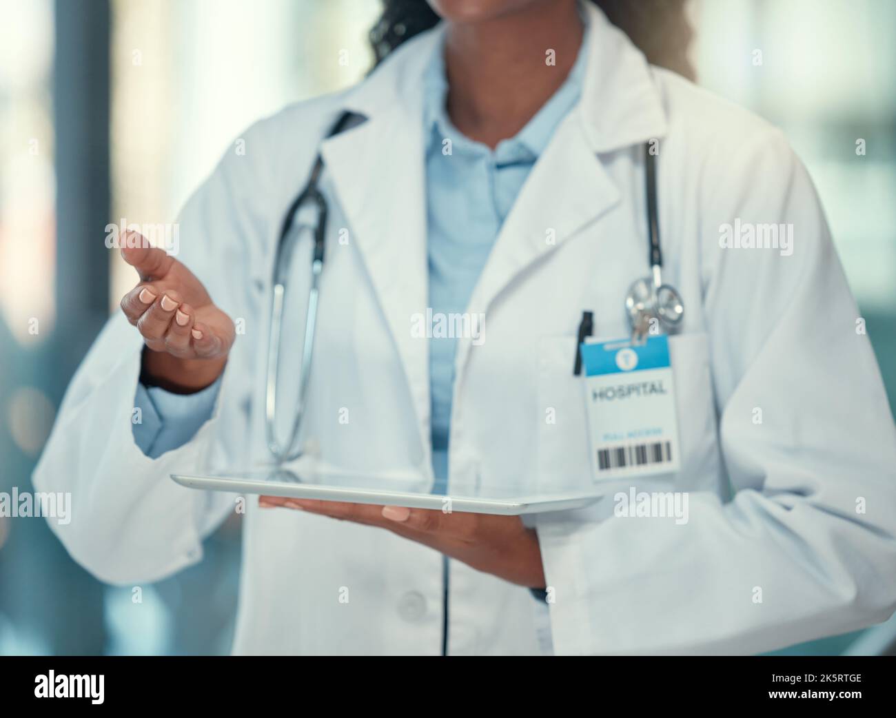 Hand of a doctor holding a digital tablet in the hospital. Closeup on ...