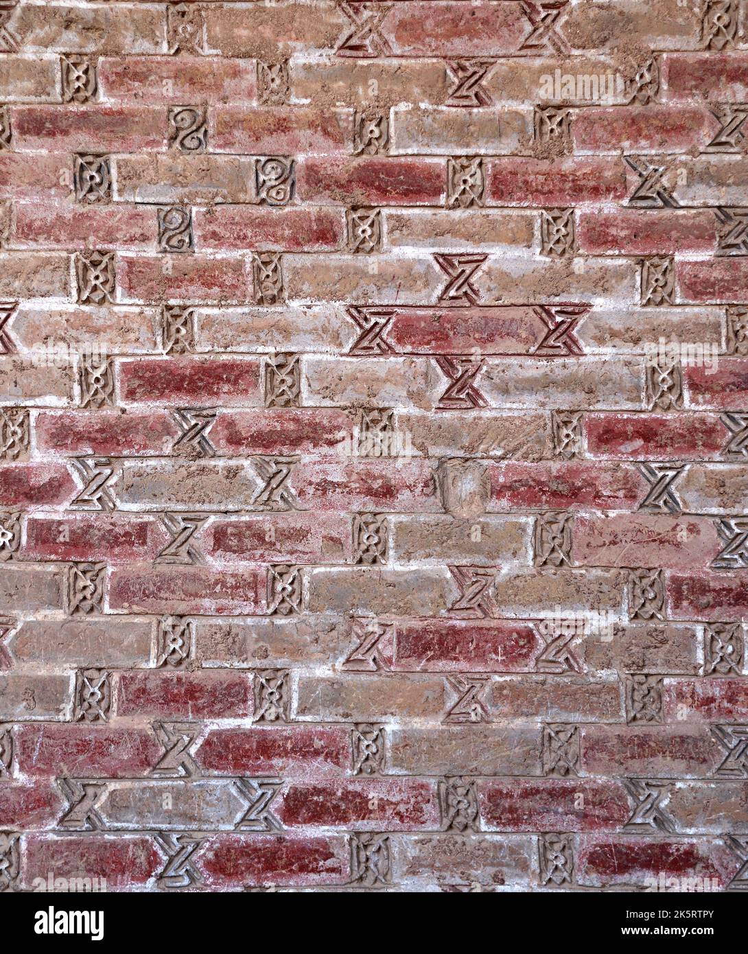 Full vertical texture of old brick wall with decorative clay elements ...