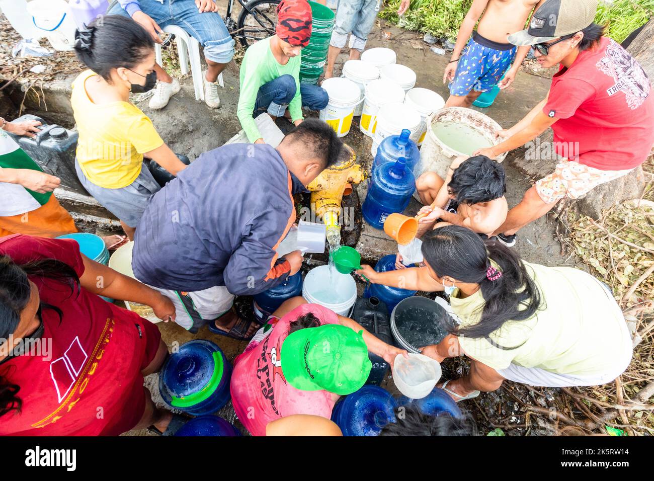 People getting water from a hydrant due to a water shortage brought by ... People getting water from a hydrant due to a water shortage brought by ...