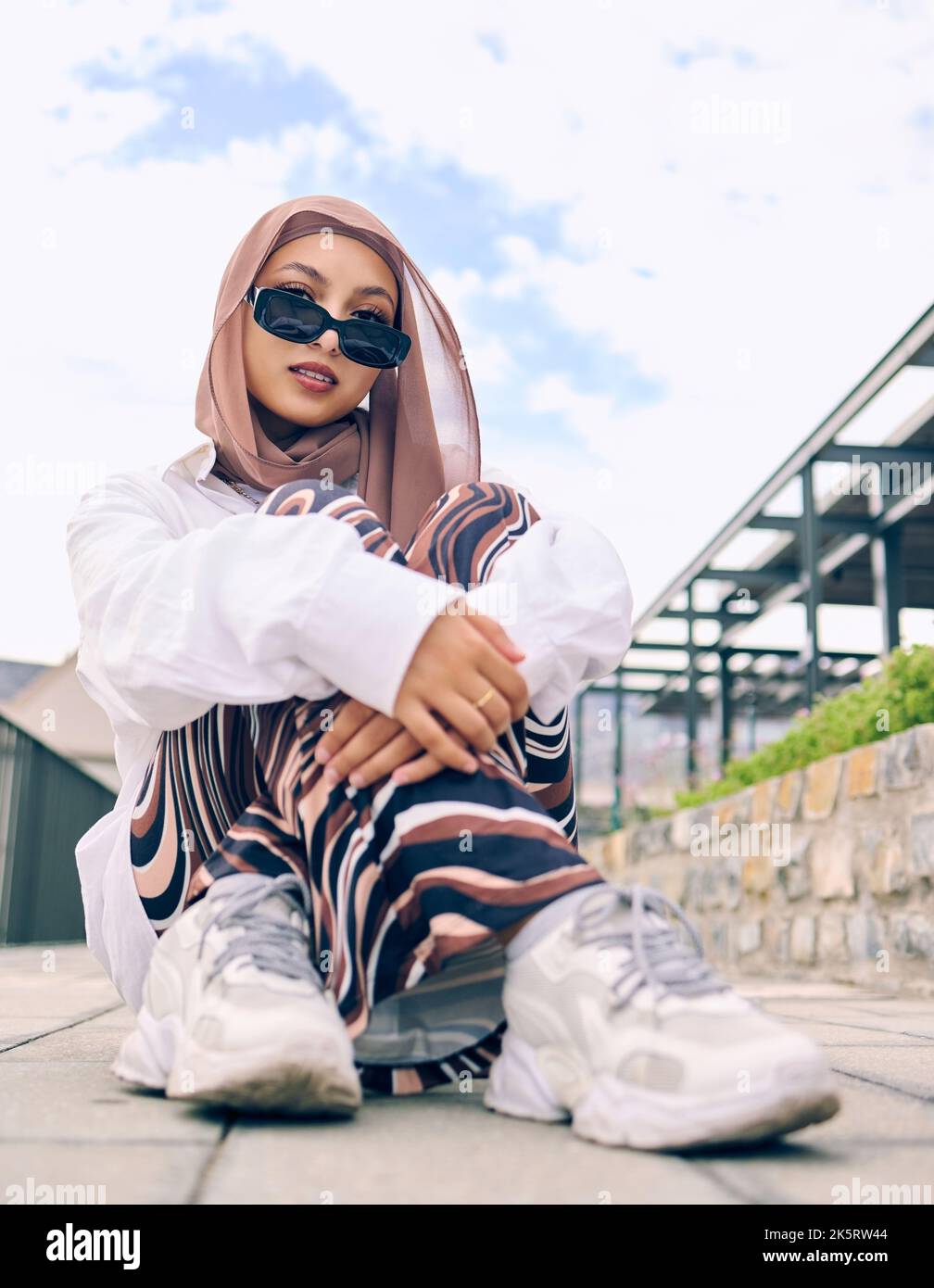 Beautiful young arab woman posing outdoors in a headscarf. Attractive ...