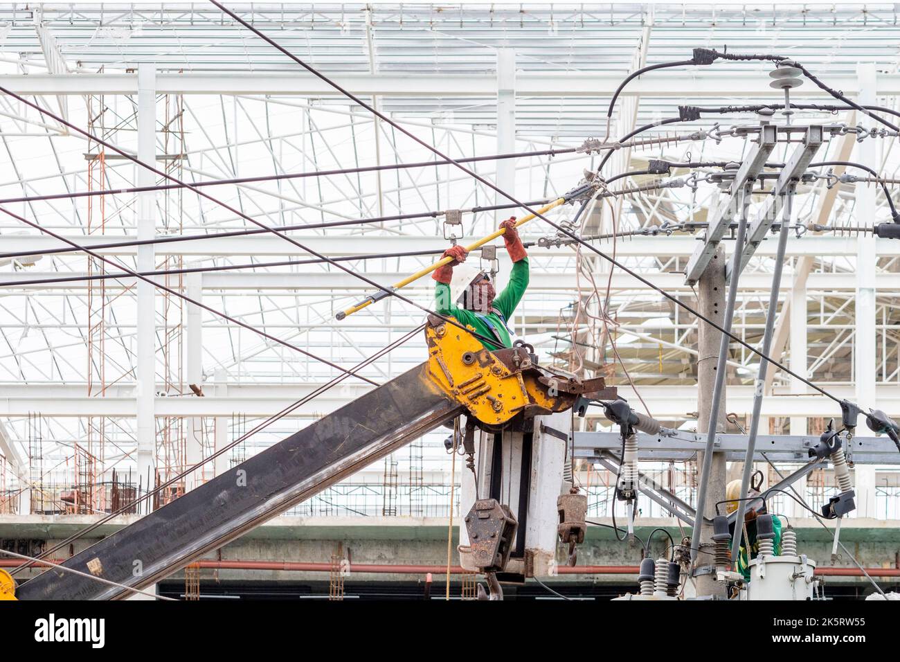 A lineman from a power company restoring power after Typhoon Odette in ...