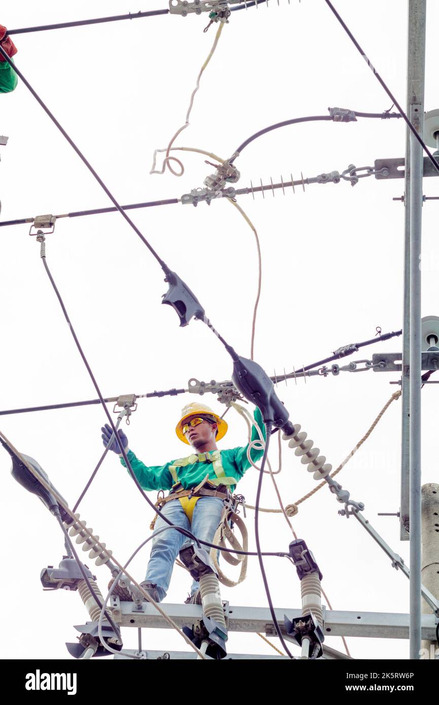 A lineman from a power company restoring power after Typhoon Odette in ...