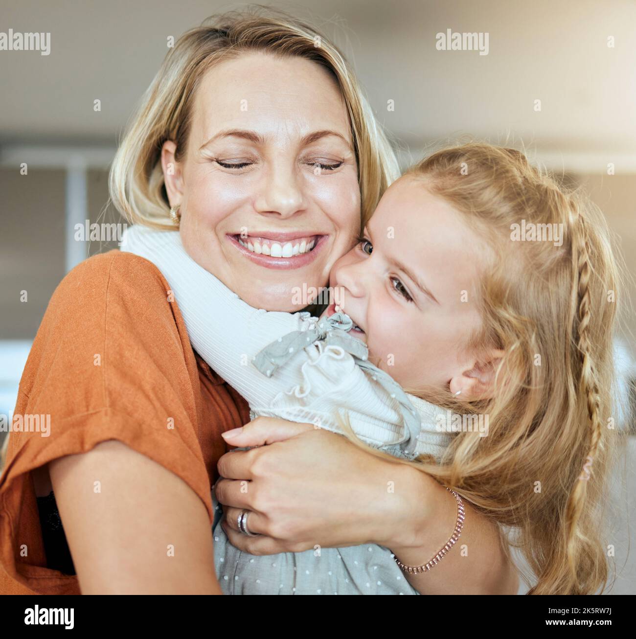 A happy family of two relaxing in the lounge and sitting on the couch together. Loving caucasian ...