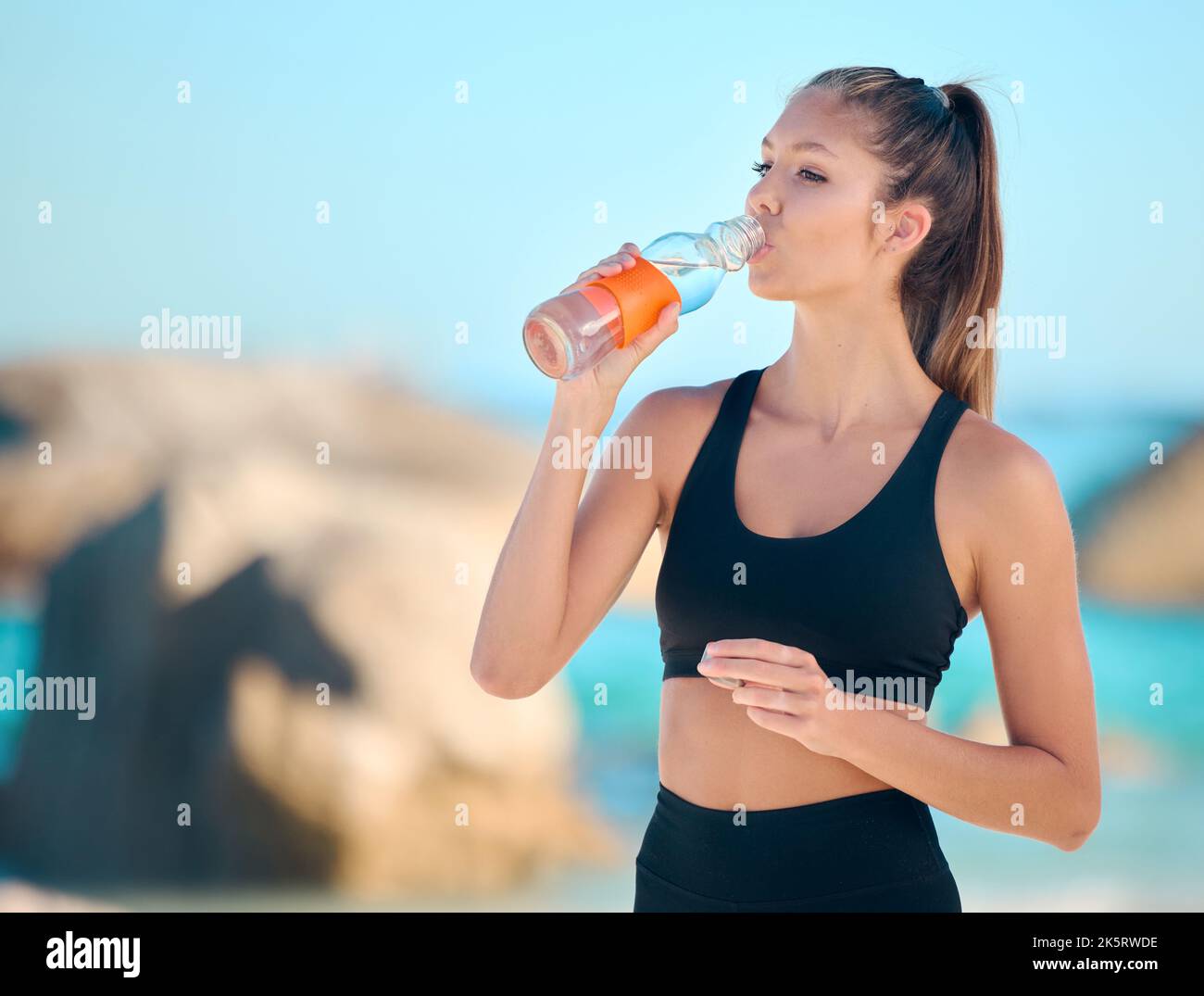 Beautiful woman practising yoga exercise on the beach. Young female ...
