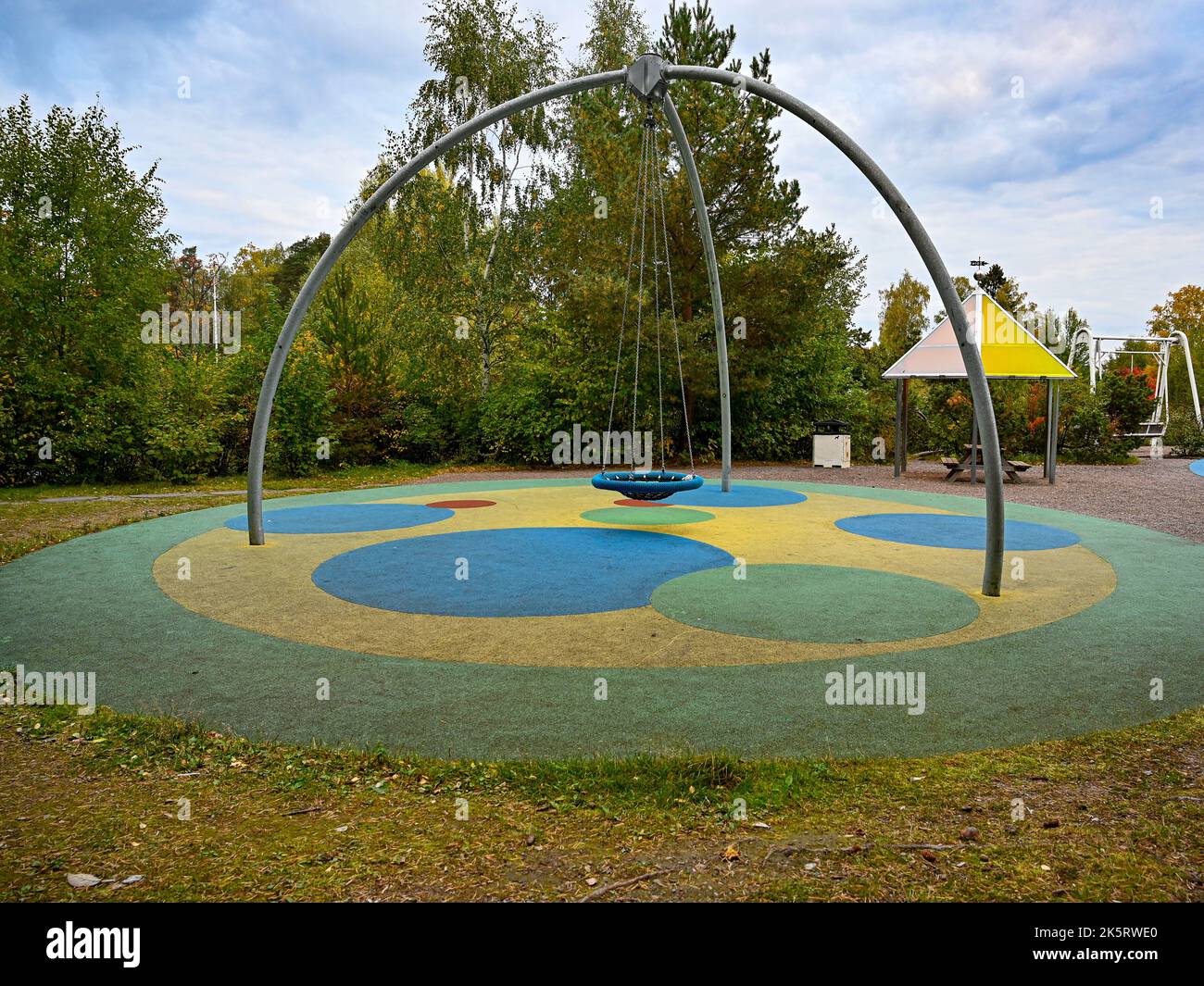 Big round swing for kids in public park Stock Photo - Alamy