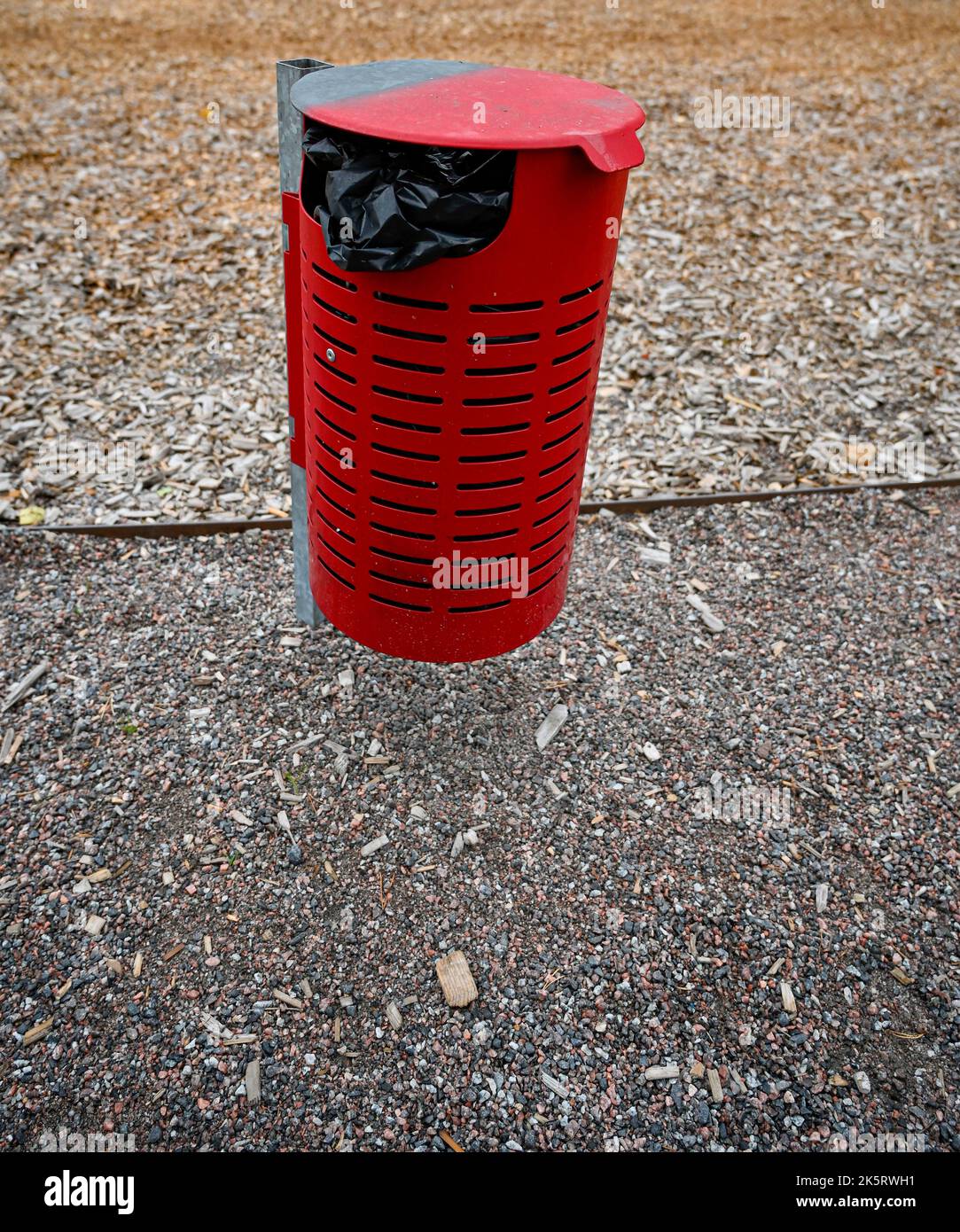 One red garbage bin in metal standing in park Stock Photo - Alamy