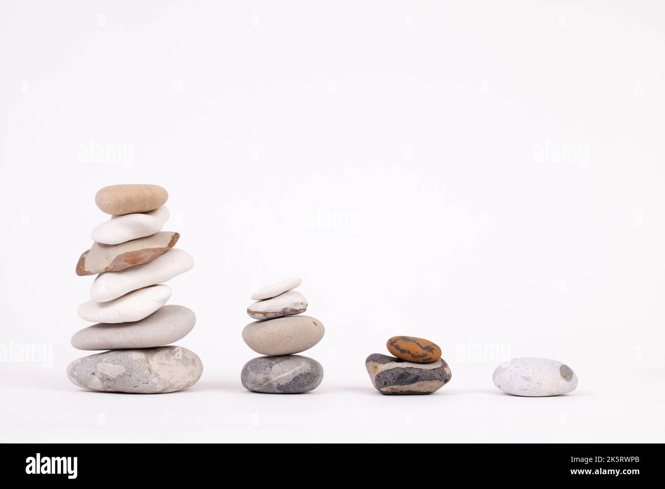 Pebbles balancing on top of each other in different columns heights ...