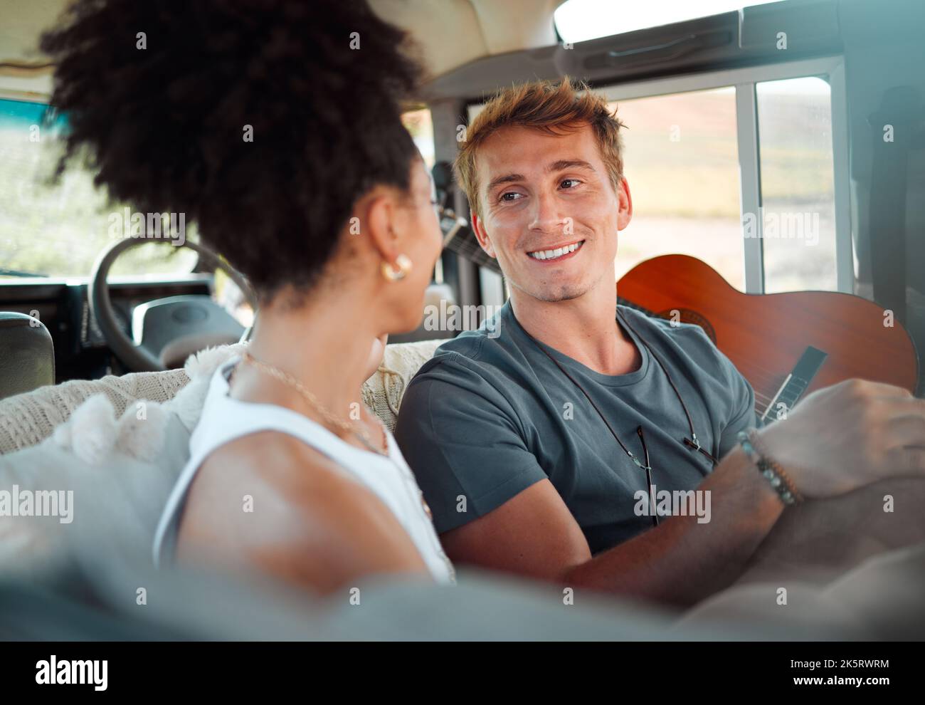 Camper, van and couple relax while travel, happy, talking and bonding ...