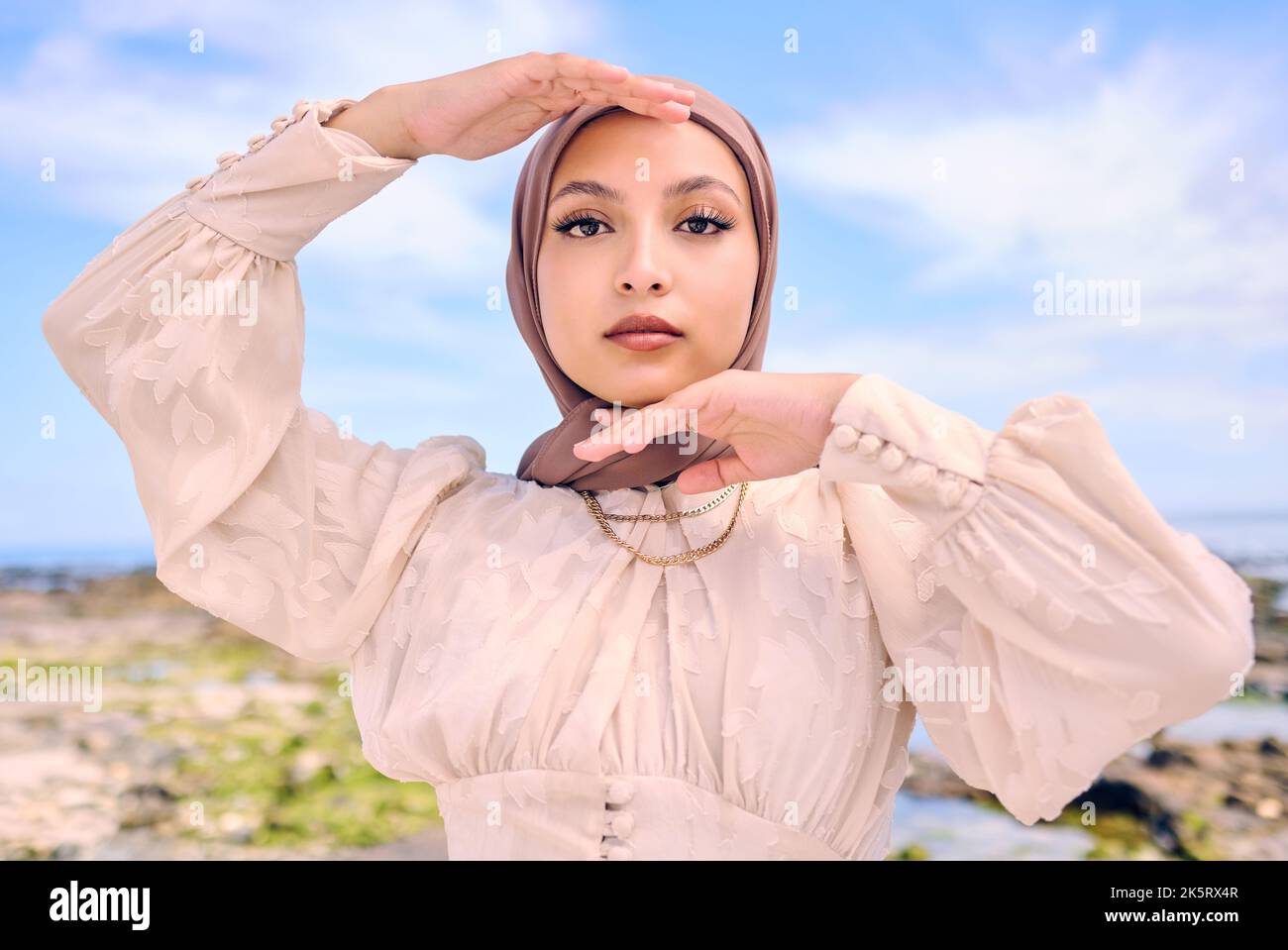 Beautiful young arab woman posing outdoors in a headscarf. Attractive ...