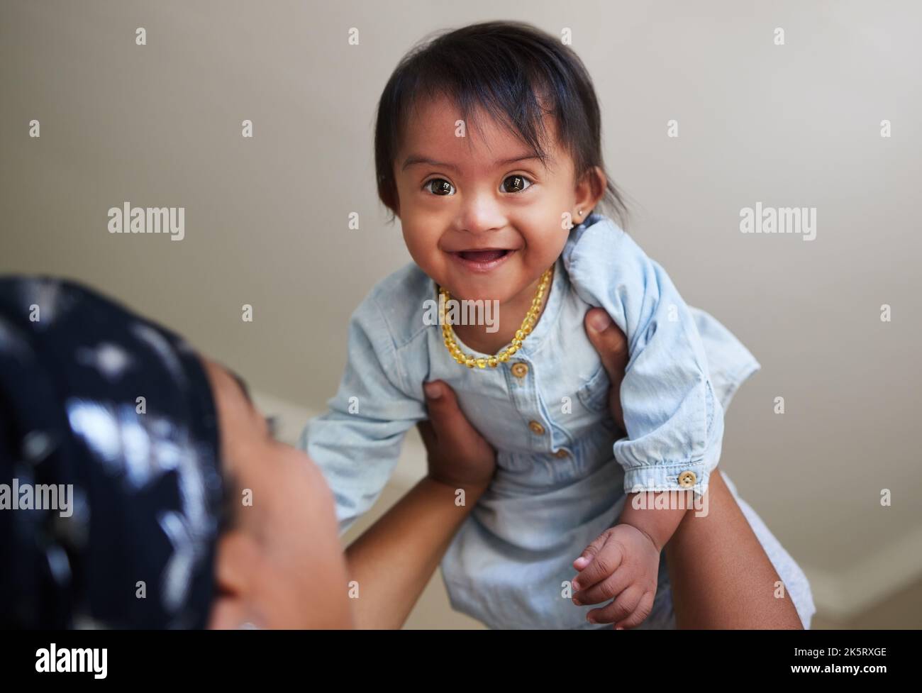 Happy, down syndrome baby and child mom care of a woman holding a kid ...