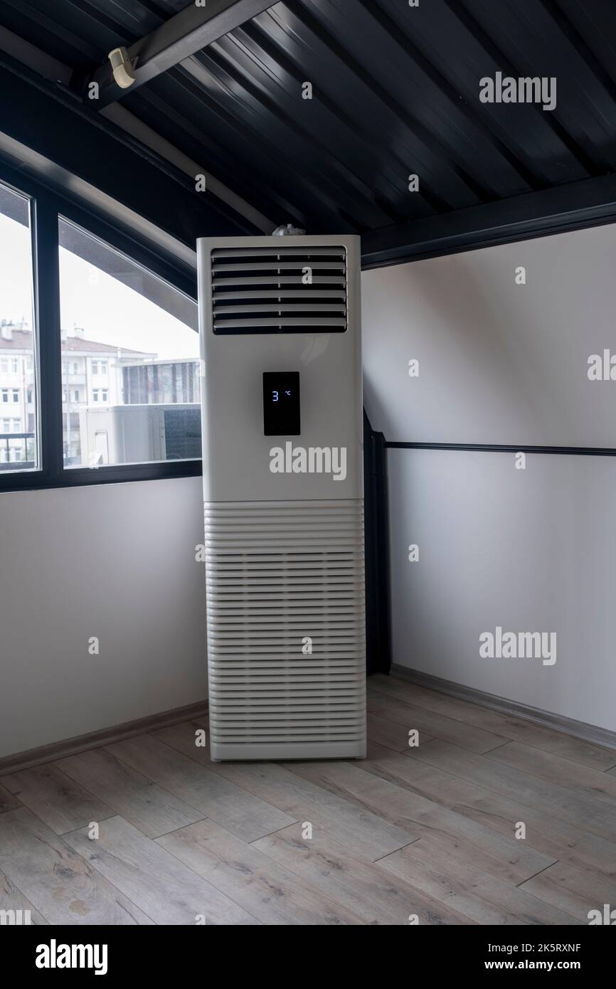 vertical Tower air conditioner indoor unit in loft office. Selective ...