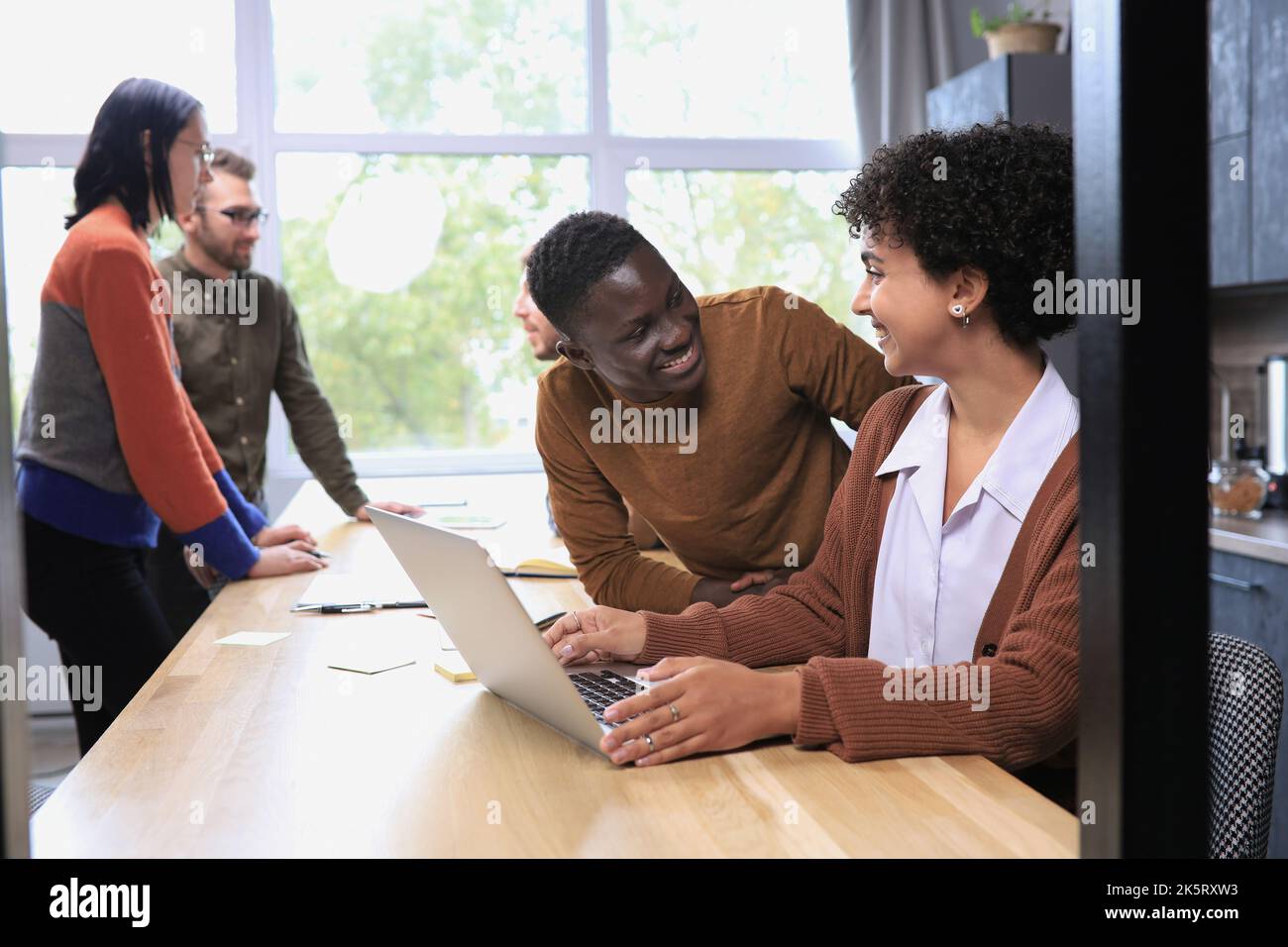 two professional businessmen discussing and using desktop computer in ...