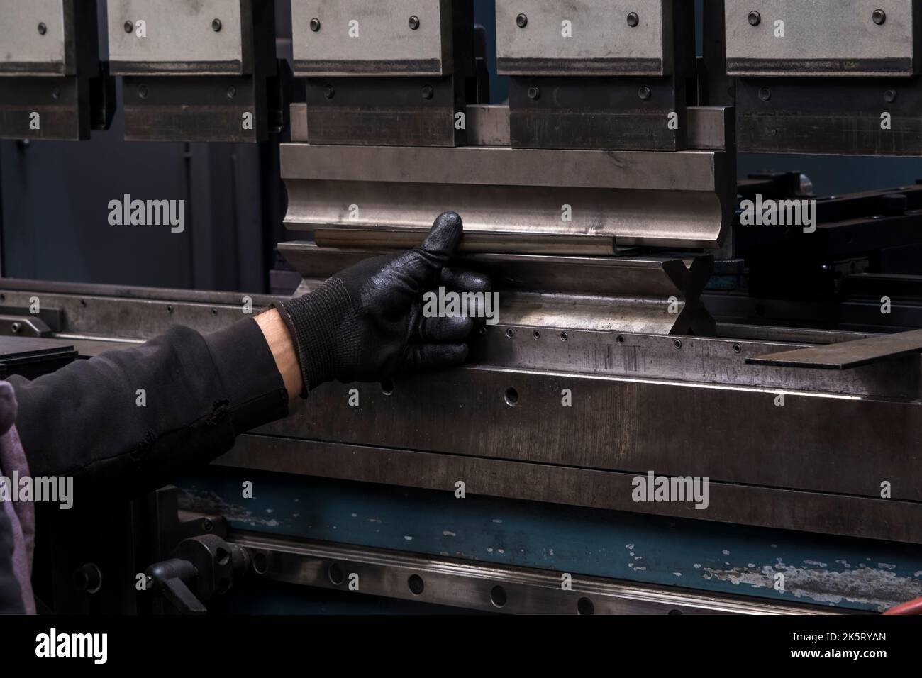 hydraulic press brake or bending machine for flat sheet metal. Worker ...