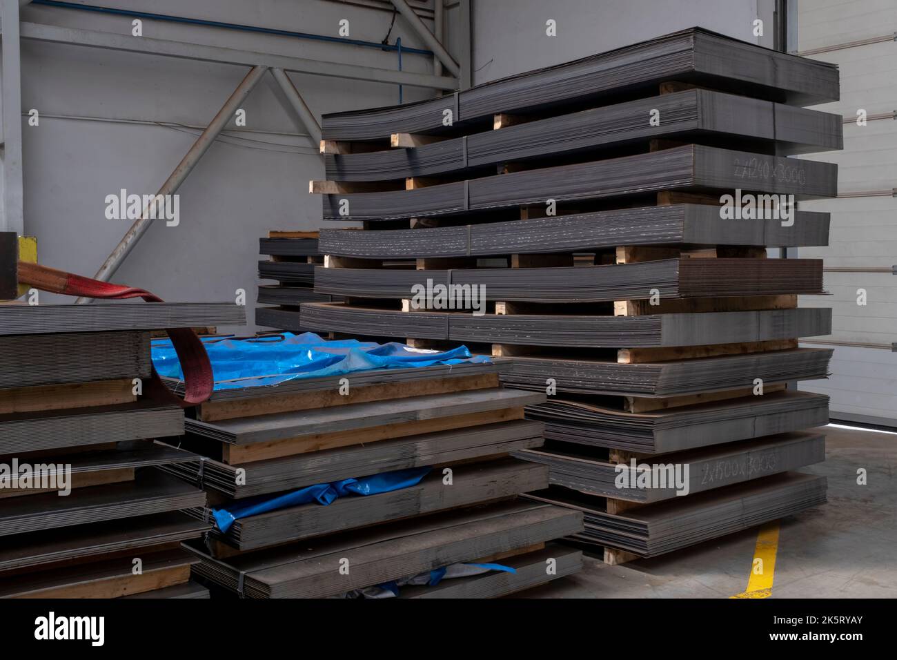 sheets of metal in the warehouse, stacked on top of each other. Stack ...