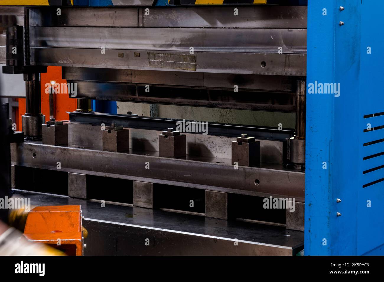 hydraulic press brake or bending machine for flat sheet metal. Worker ...