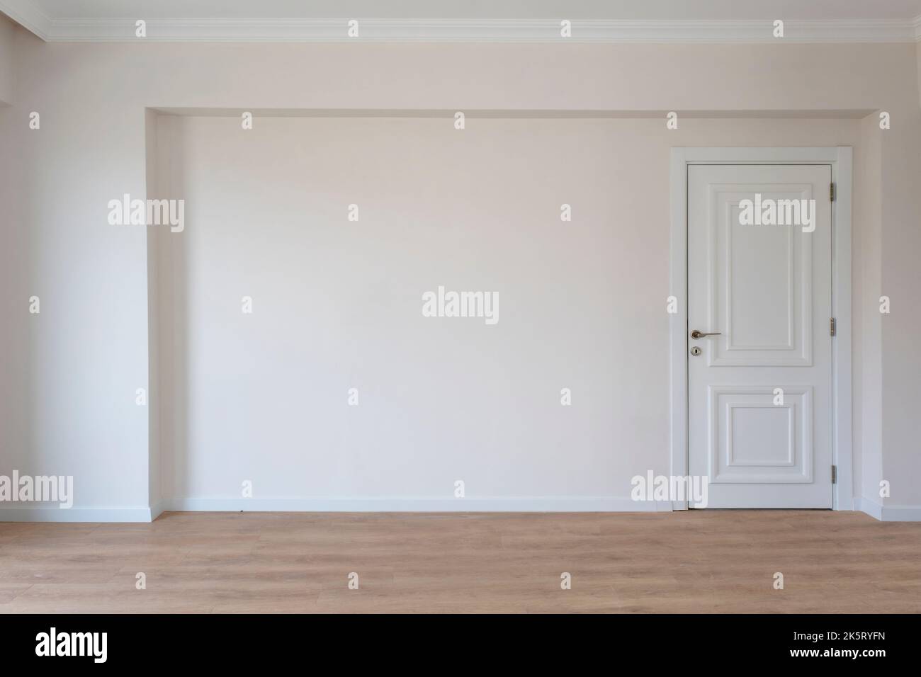 Empty room in flat flat with champagne color walls and wooden floor ...