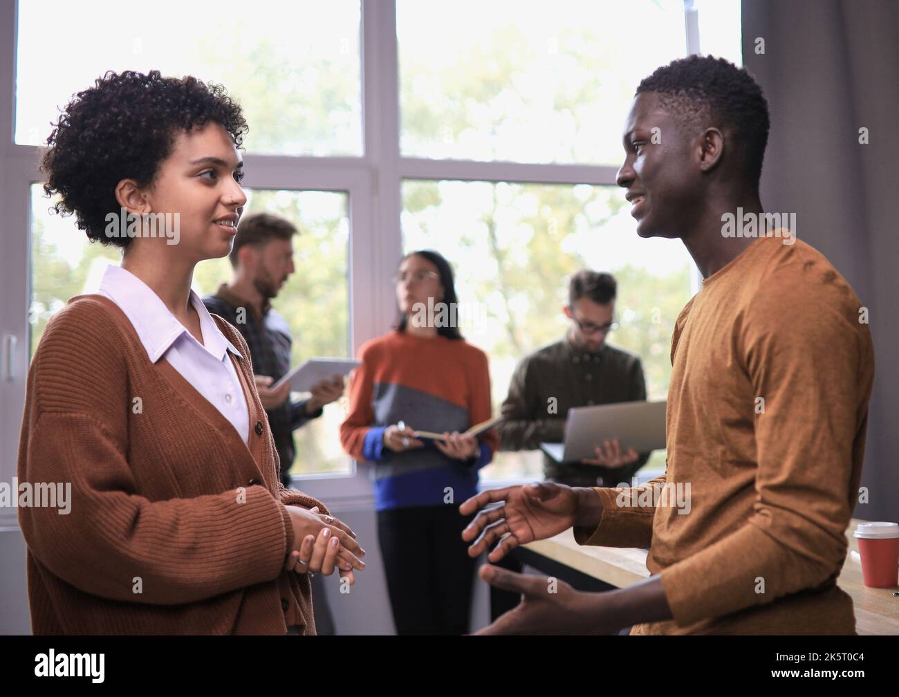 two professional businessmen discussing and using desktop computer in ...