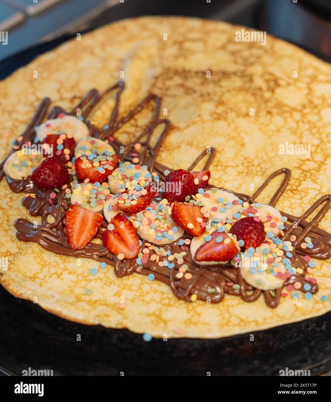 Delicious nutella and chocolate syrup crepe, with a scoop of ice cream ...