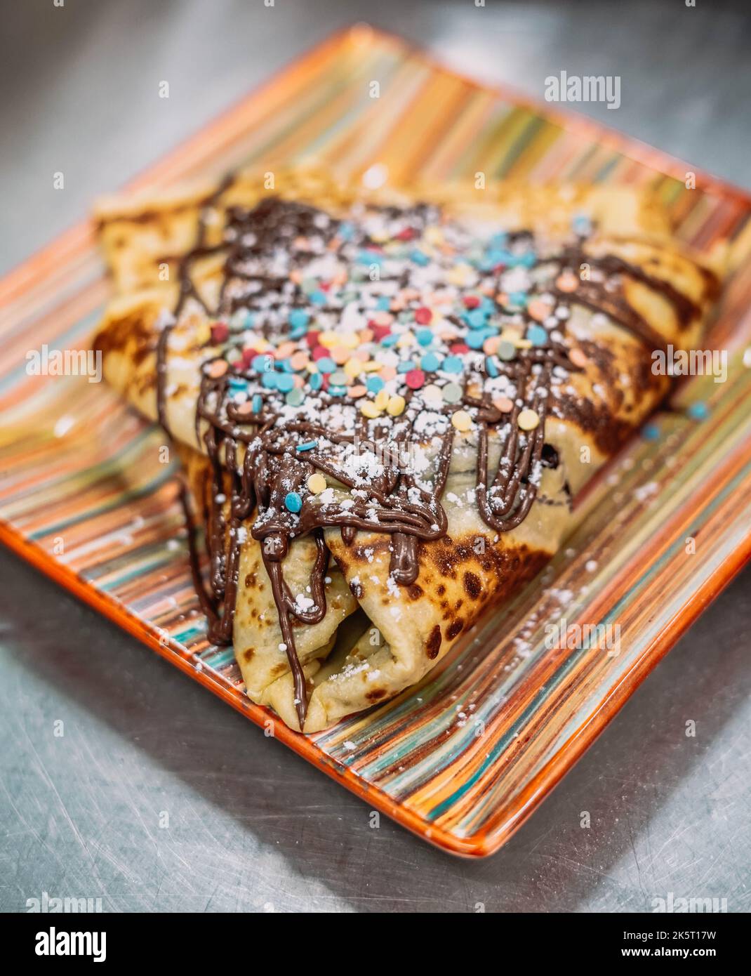 Delicious nutella and chocolate syrup crepe, with a scoop of ice cream ...