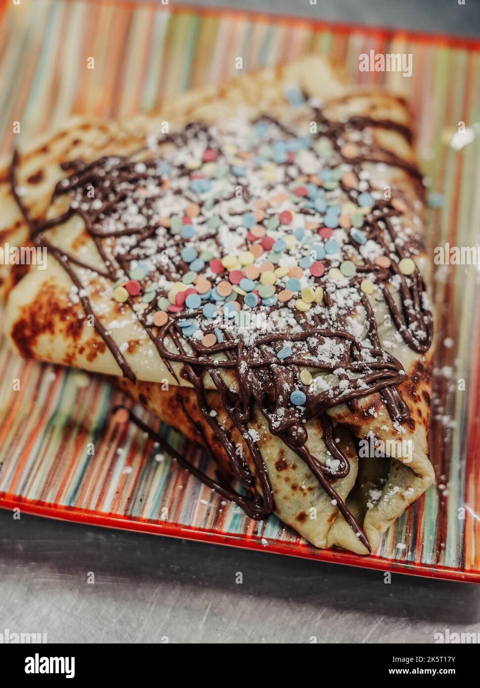 Delicious nutella and chocolate syrup crepe, with a scoop of ice cream ...