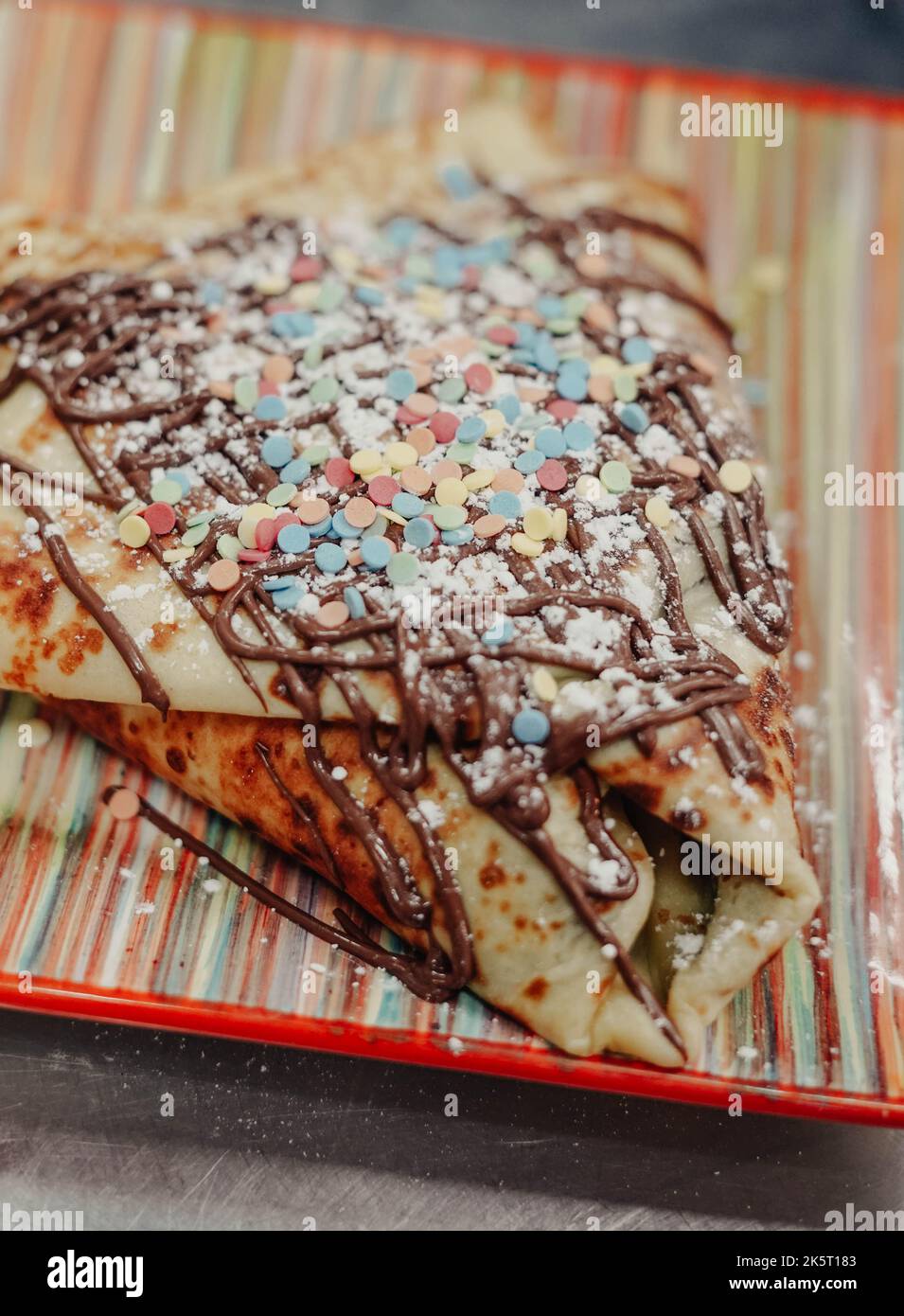 Delicious nutella and chocolate syrup crepe, with a scoop of ice cream ...