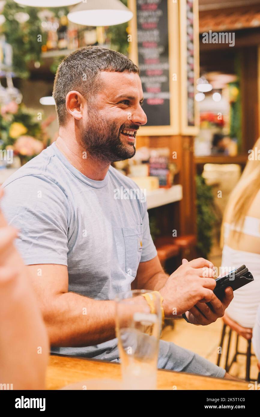 Middle-aged man sitting on the terrace of a coffee shop Stock Photo - Alamy