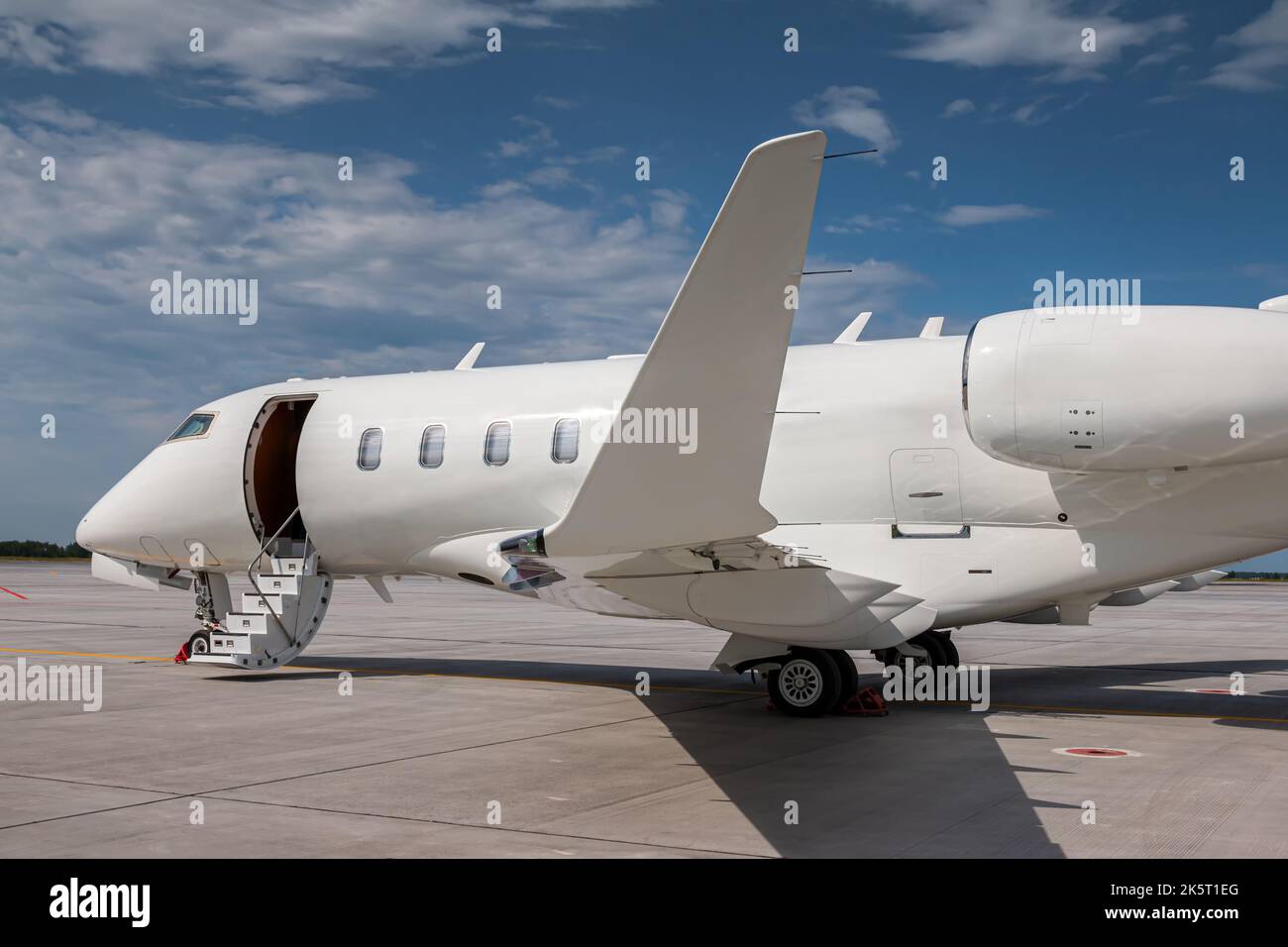 Close-up modern white private jet with an opened gangway door at the ...