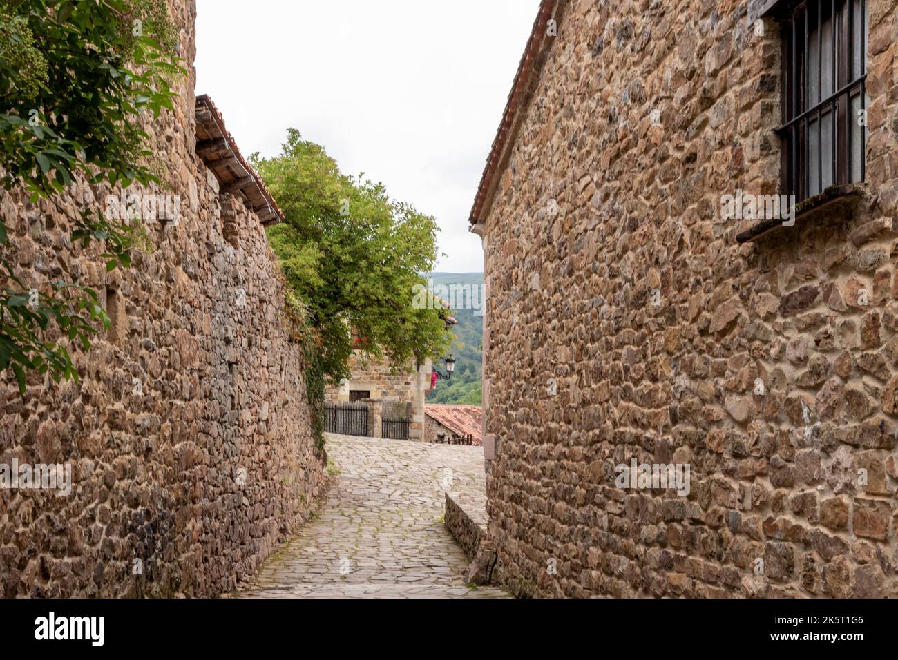 street and typical buildings of the town of barcena mayor, in cantabria ...